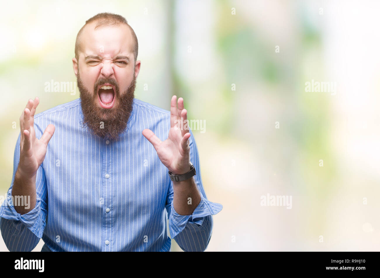 Young caucasian hipster man over isolated background crazy and mad ...