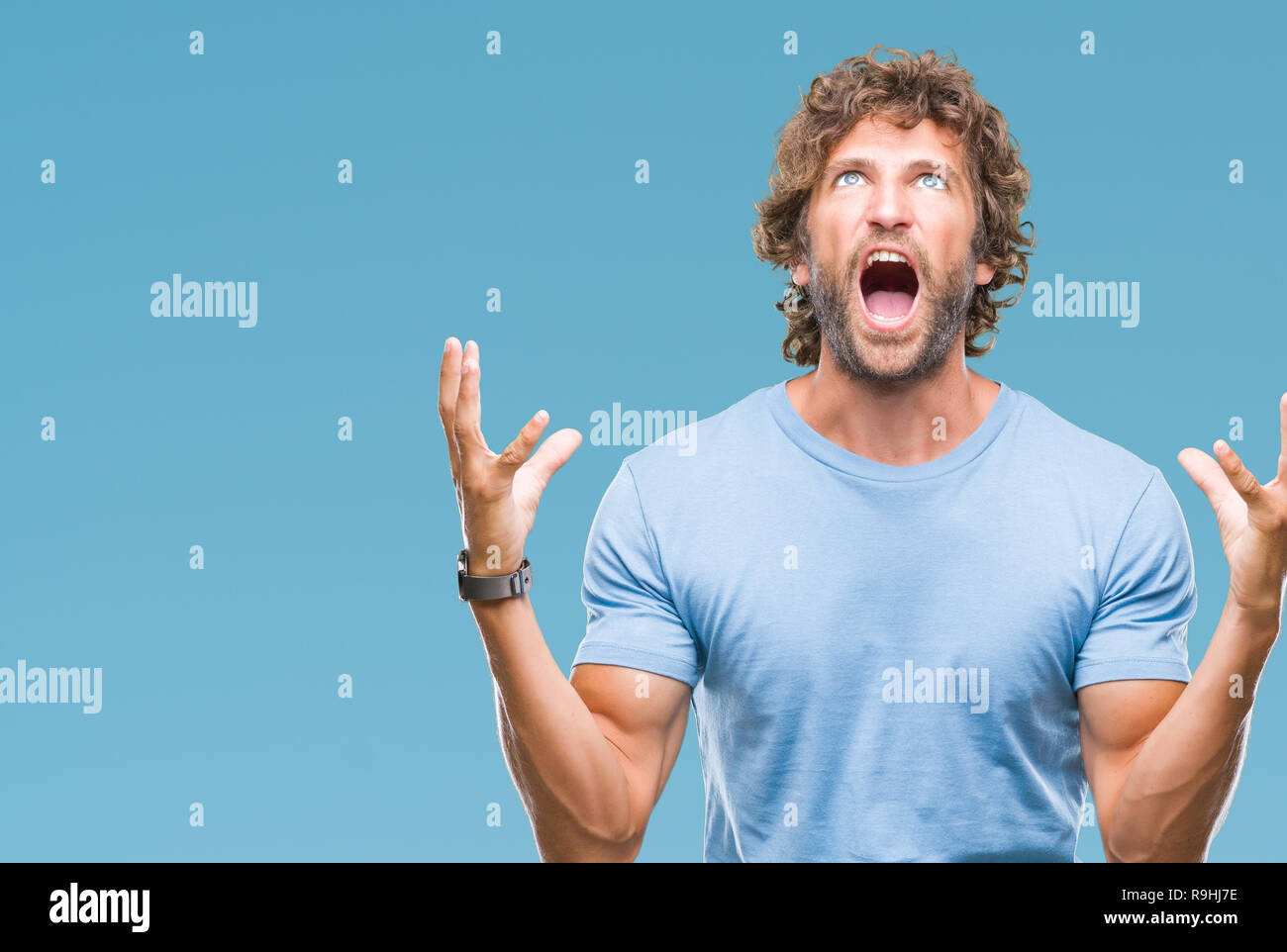 Handsome hispanic model man over isolated background crazy and mad ...