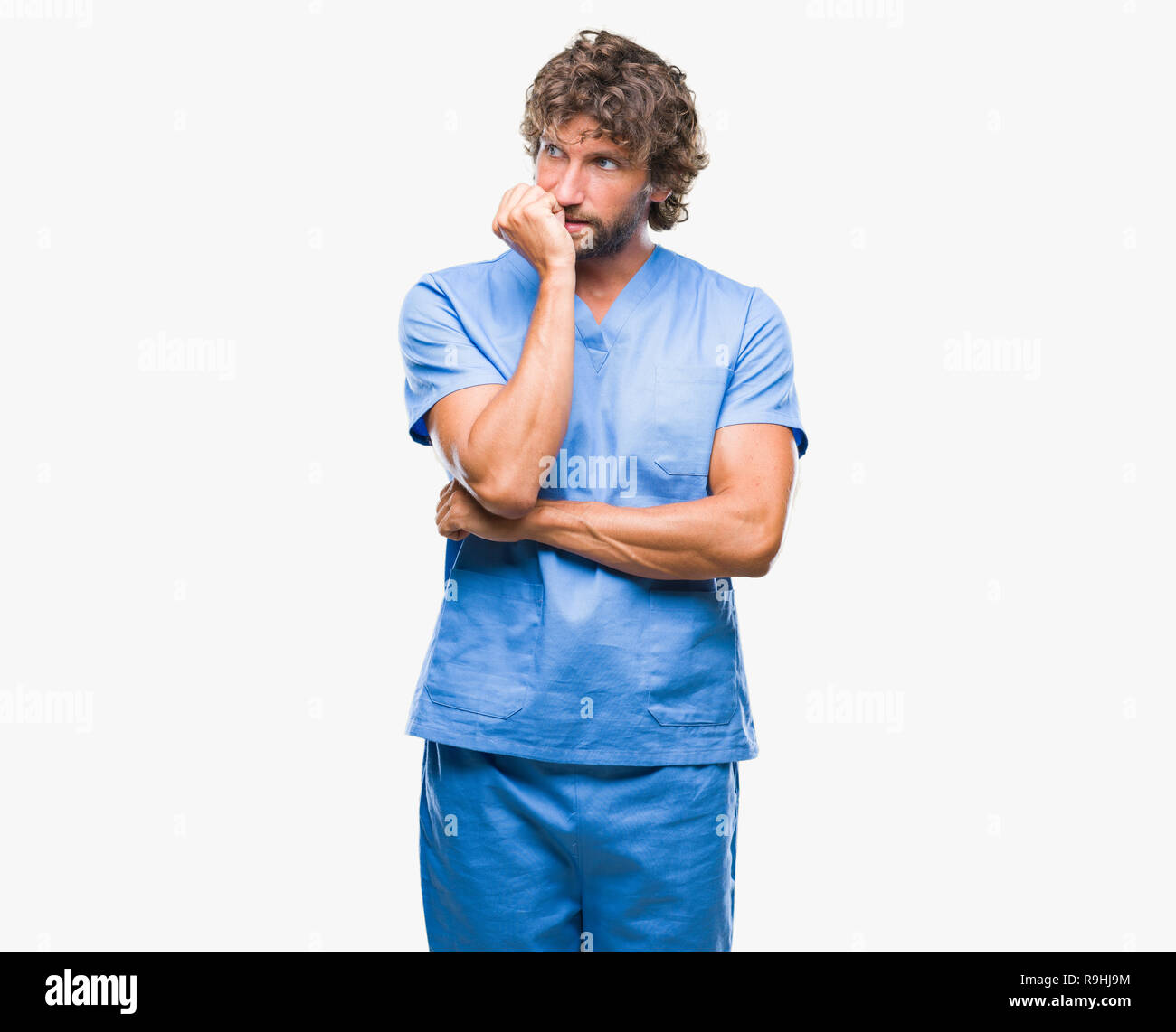Handsome hispanic surgeon doctor man over isolated background looking ...