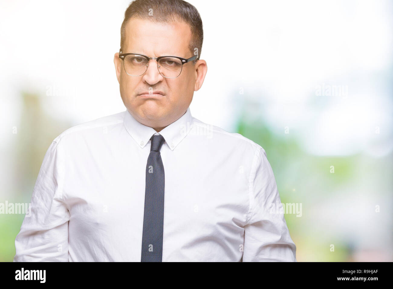 Middle age bussines arab man wearing glasses over isolated background ...