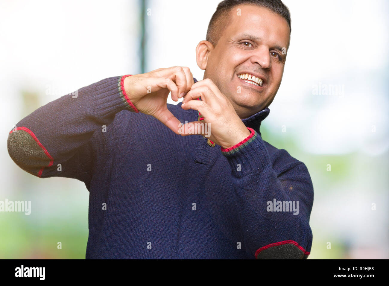 Middle age arab man over isolated background smiling in love showing ...