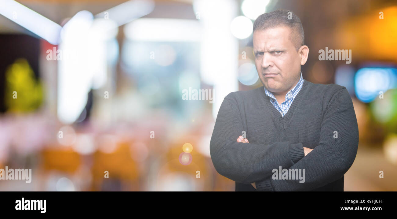 Handsome middle age man over isolated background skeptic and nervous ...