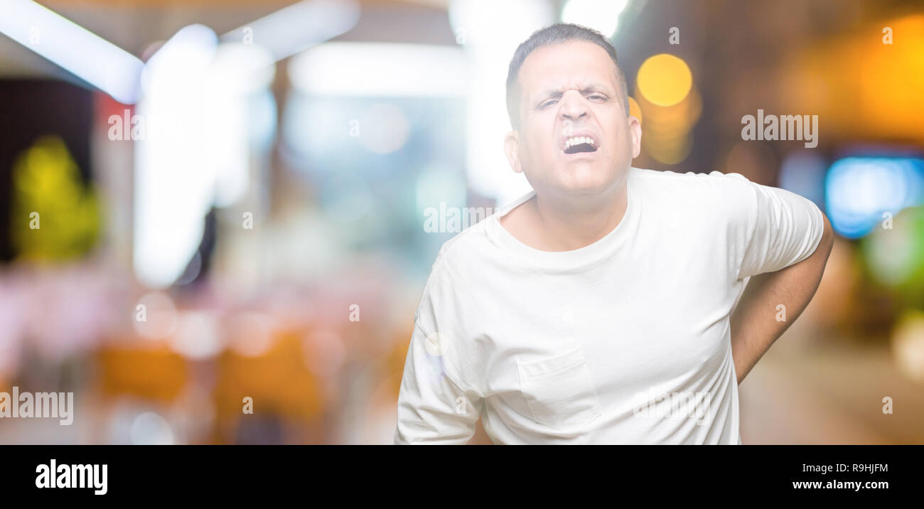 Middle age arab man wearig white t-shirt over isolated background ...