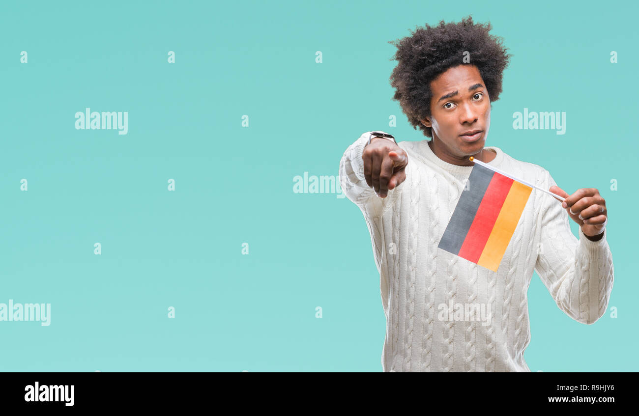 Afro american man flag of Germany over isolated background pointing ...
