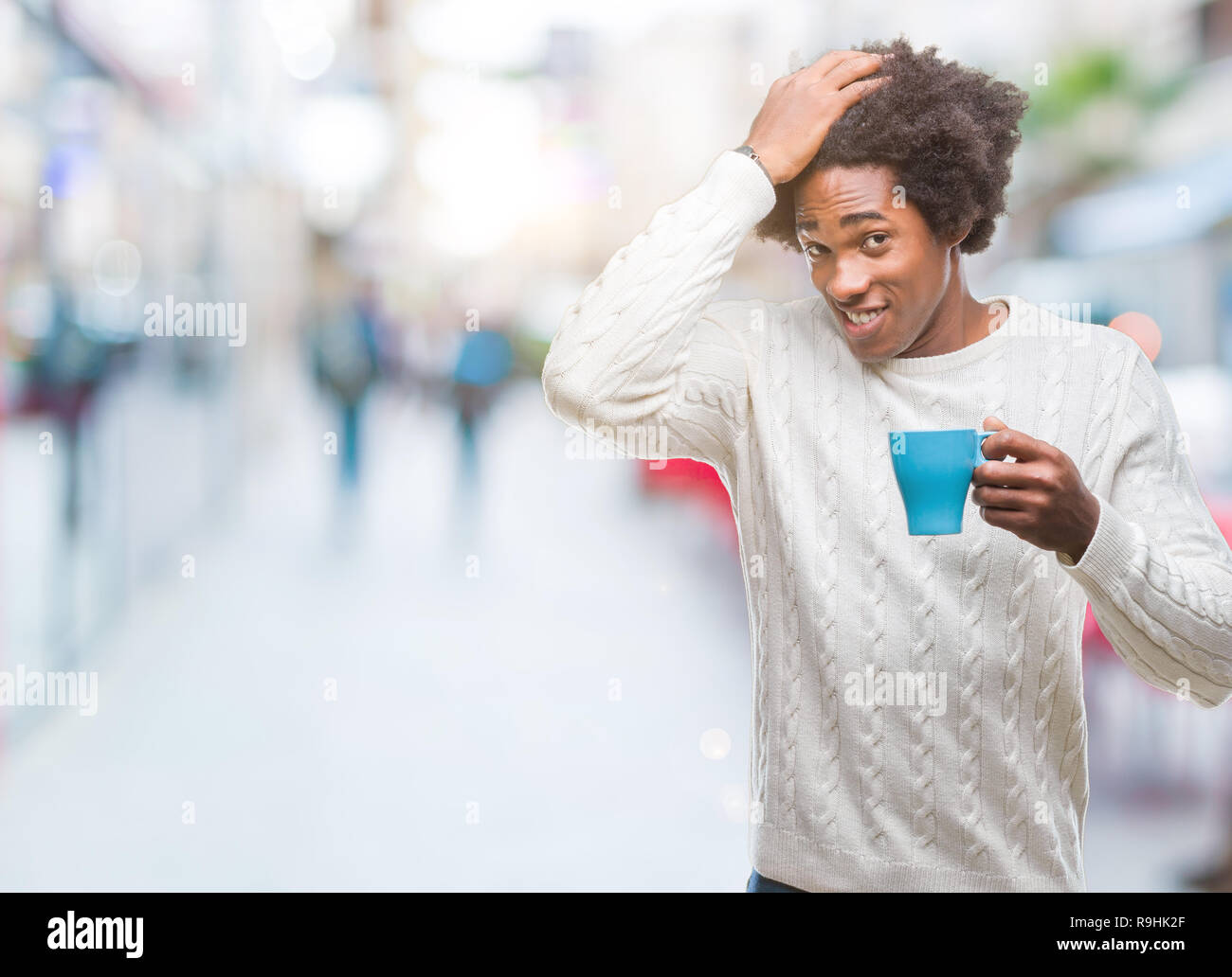 Afro american man drinking cup of coffee over isolated background ...
