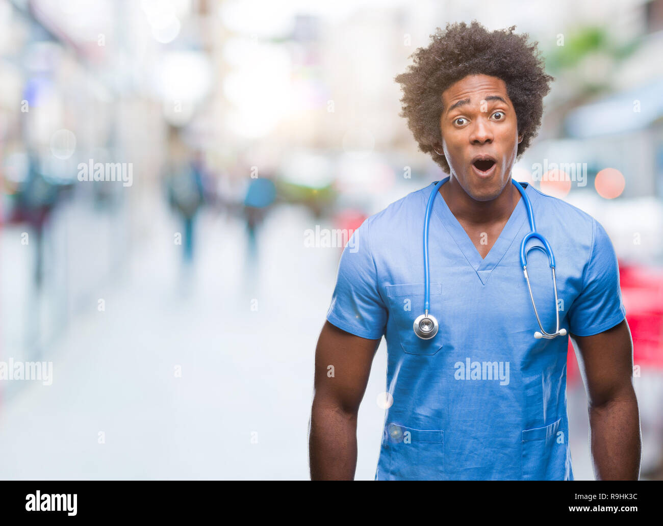 Afro american surgeon doctor man over isolated background afraid and ...