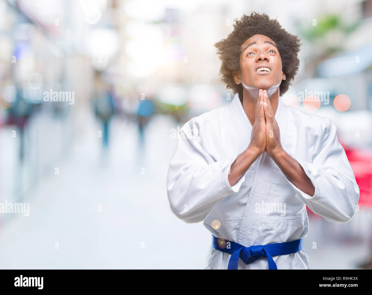 Afro american man wearing karate kimono over isolated background ...