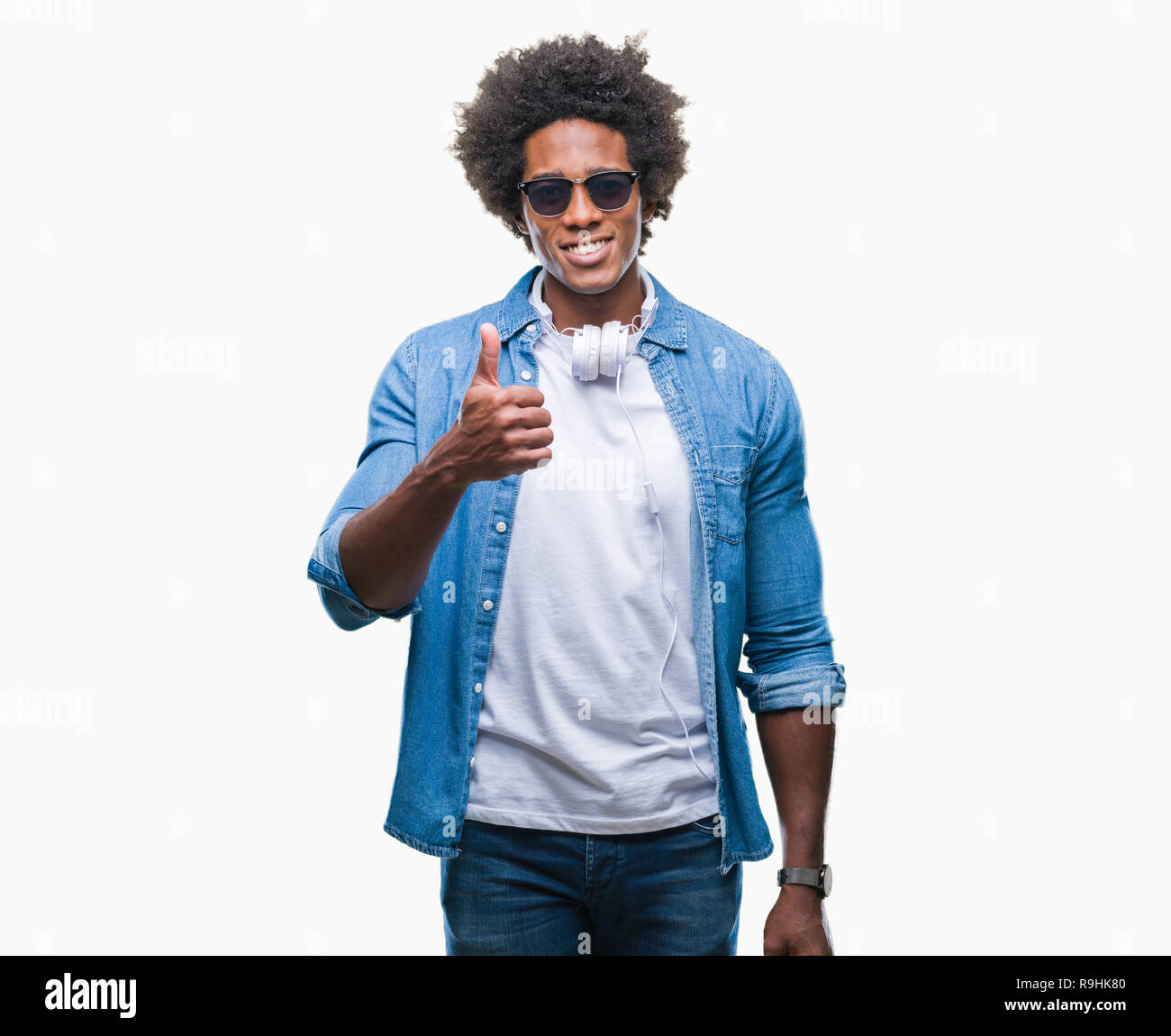 Afro american man wearing headphones listening to music over isolated ...