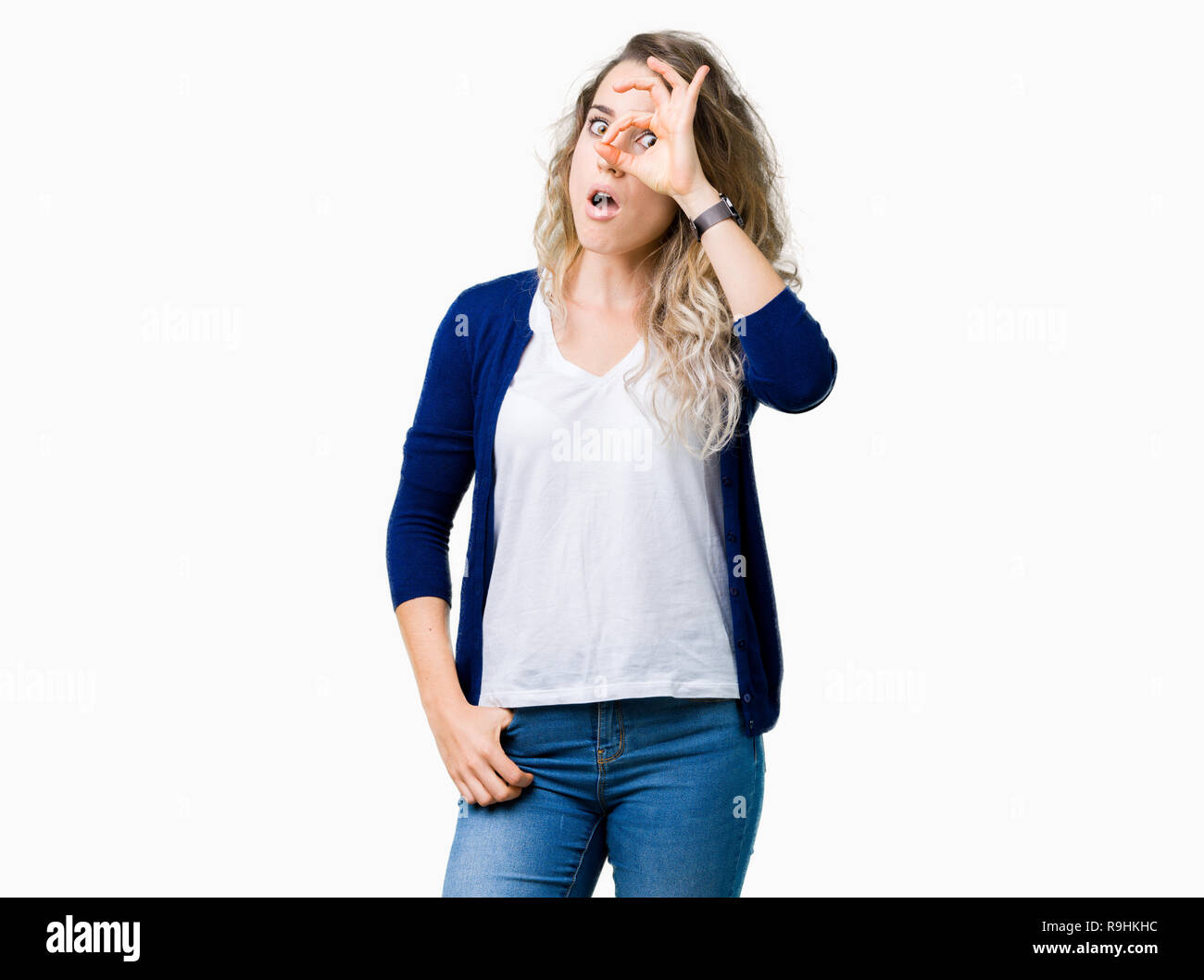 Beautiful young blonde woman over isolated background doing ok gesture ...