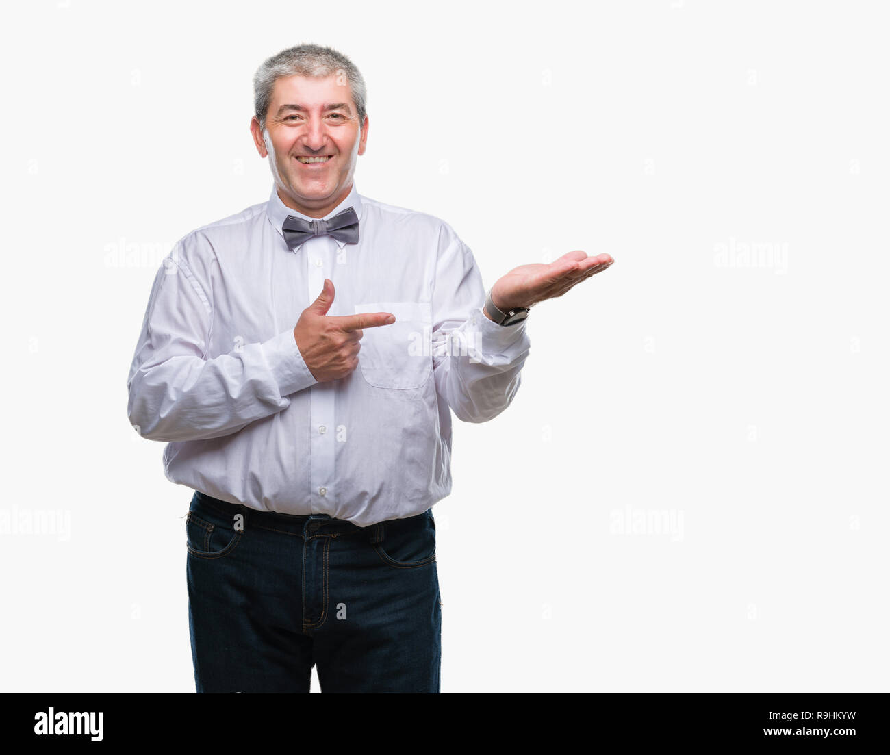Handsome senior man wearing bow tie over isolated background amazed and ...
