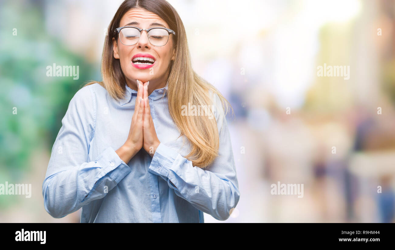 Young beautiful business woman wearing glasses over isolated background ...