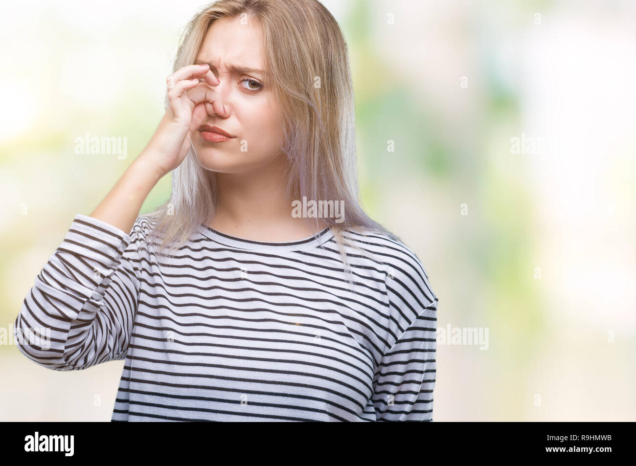 Young Blonde Woman Over Isolated Background Smelling Something Stinky