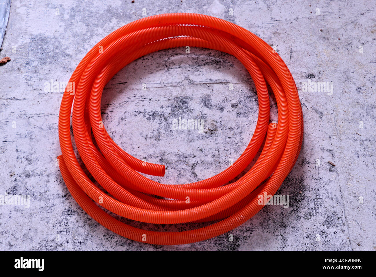 orange plastic tube on the ground Stock Photo - Alamy