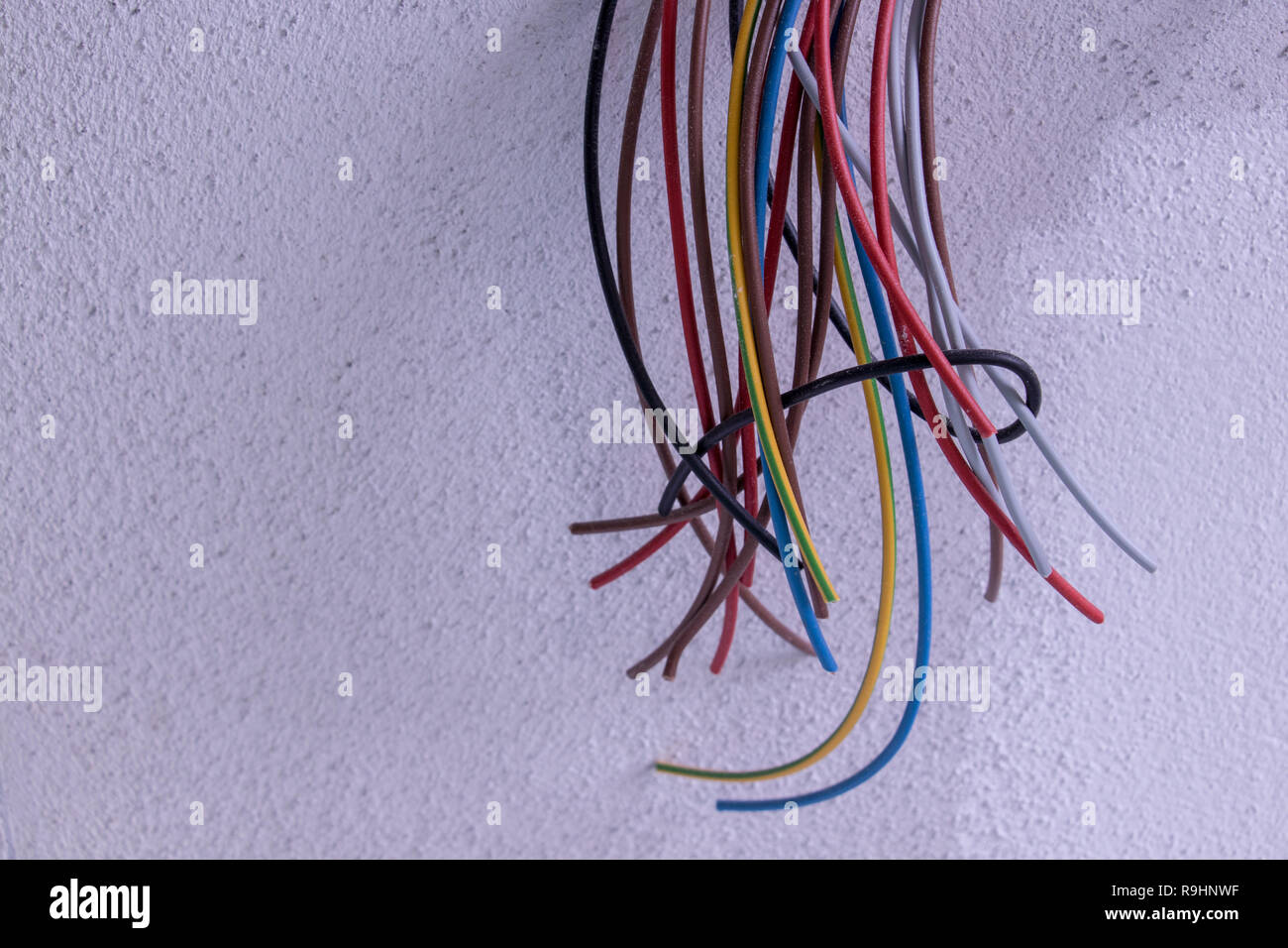 a bunch of different cables looking from wall Stock Photo - Alamy