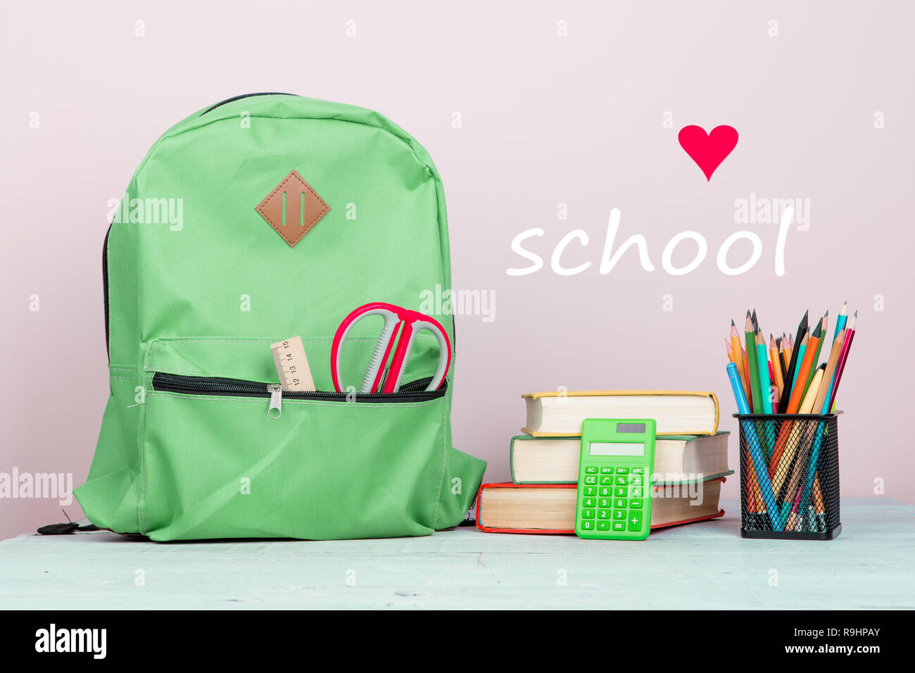 Green backpack and school supplies: notepad, books, scissors, pens ...