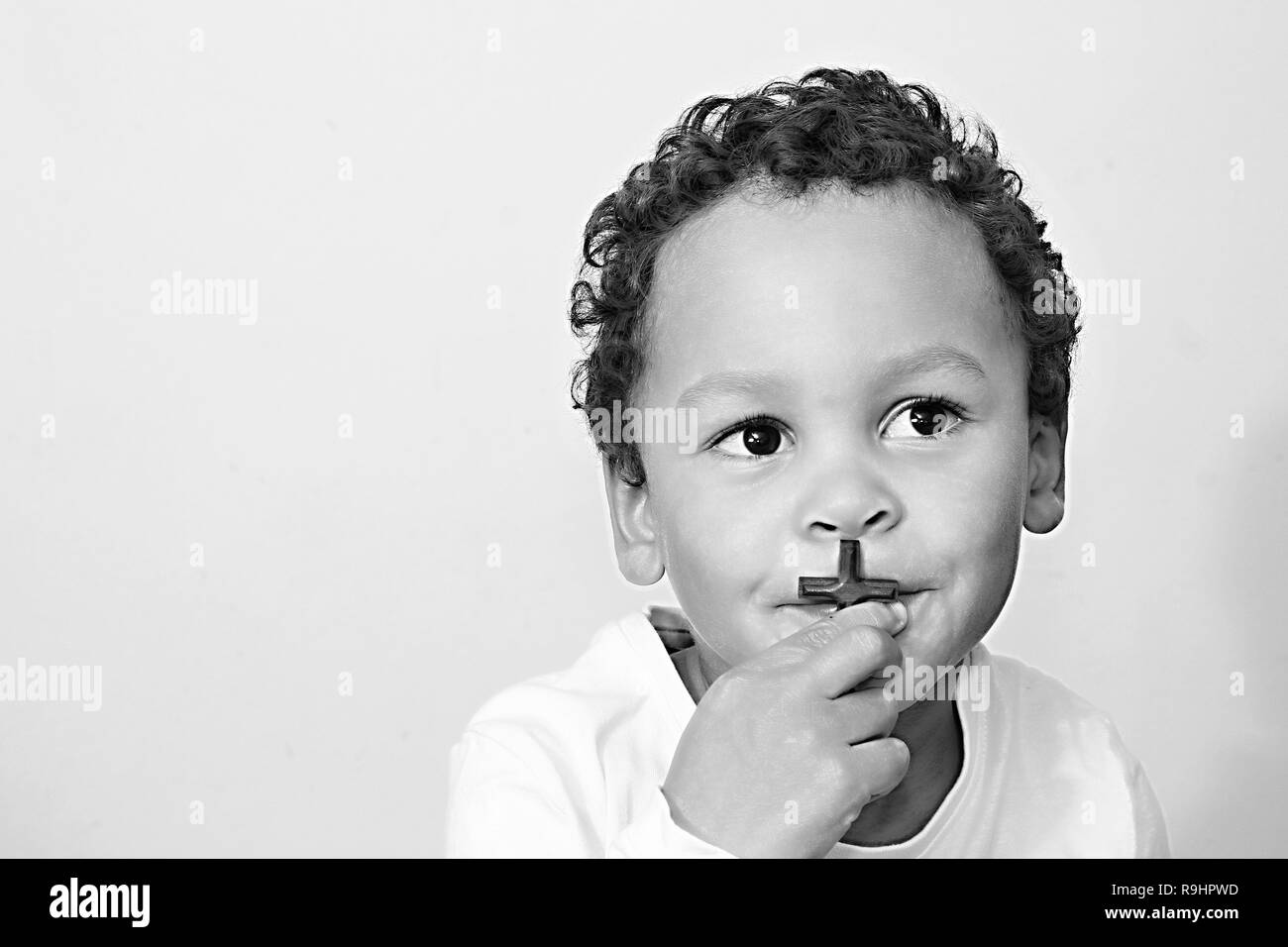 boy praying kissing the cross on white background with people stock ...