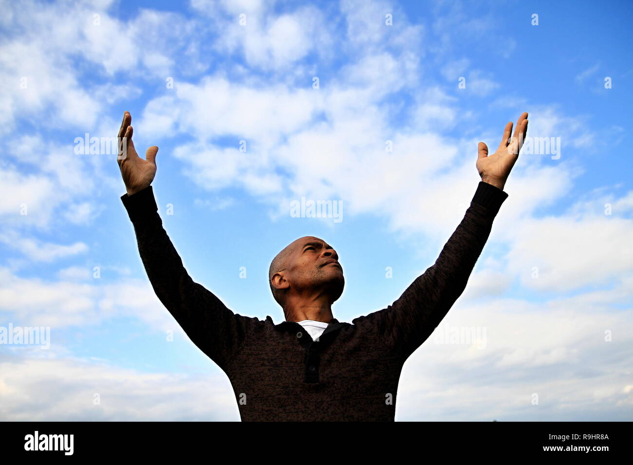 man praying to god with hands together Caribbean man praying stock ...