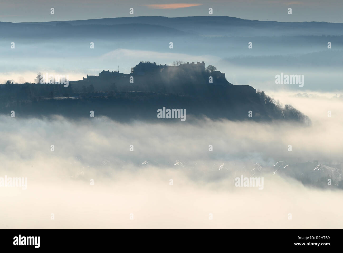 Stirling Castle is silhouetted in winter sunshine as freezing fog ...