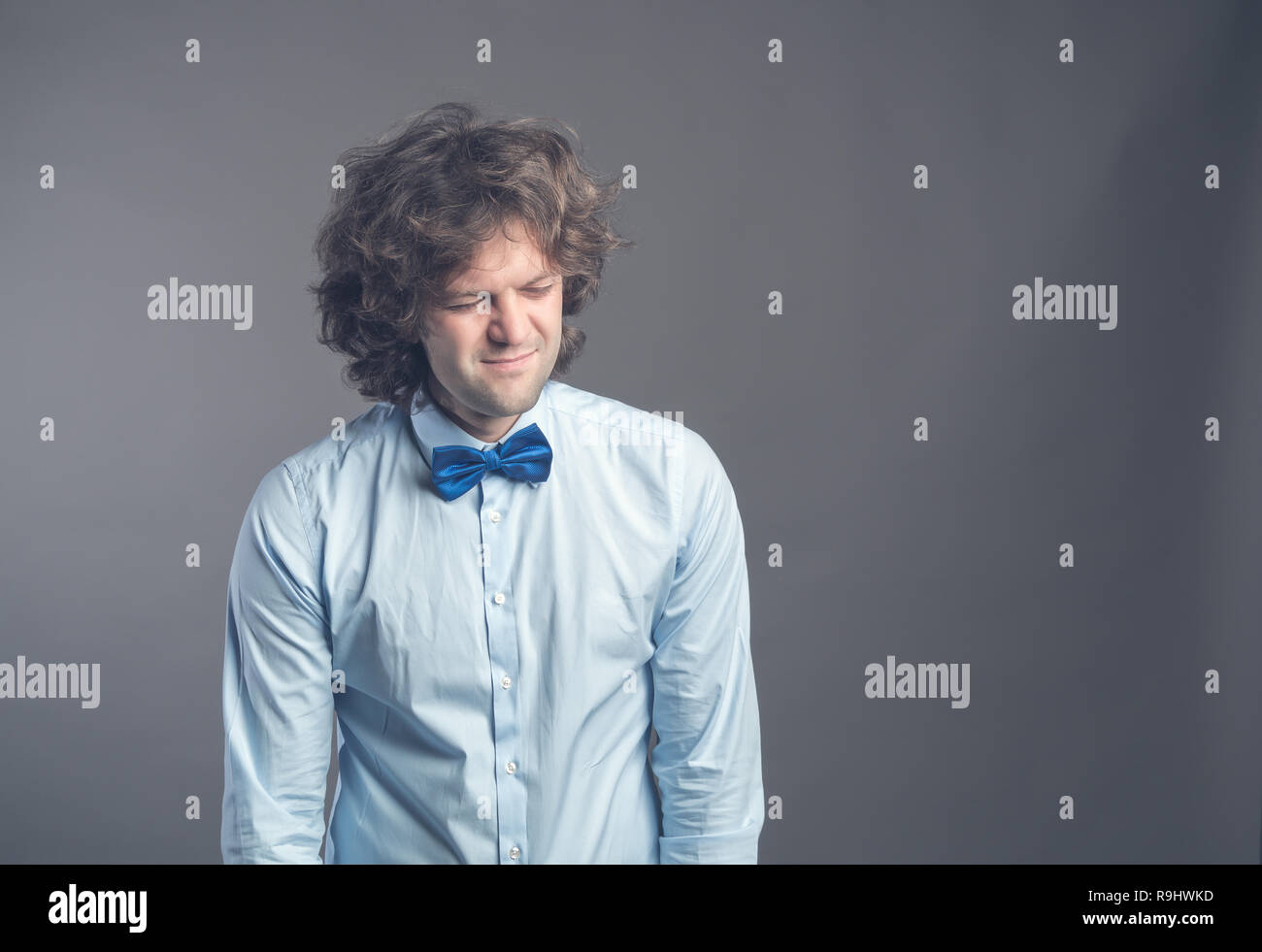 Portrait of exhausted sad guy with shaggy hair standing and looking ...