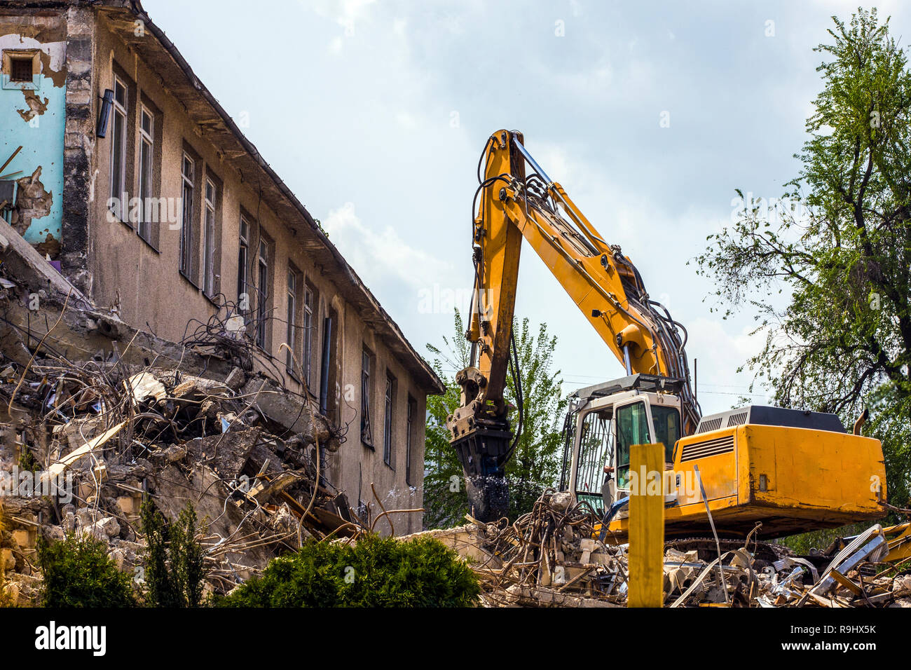 demolition of a building with a hydraulic excavator Stock Photo - Alamy