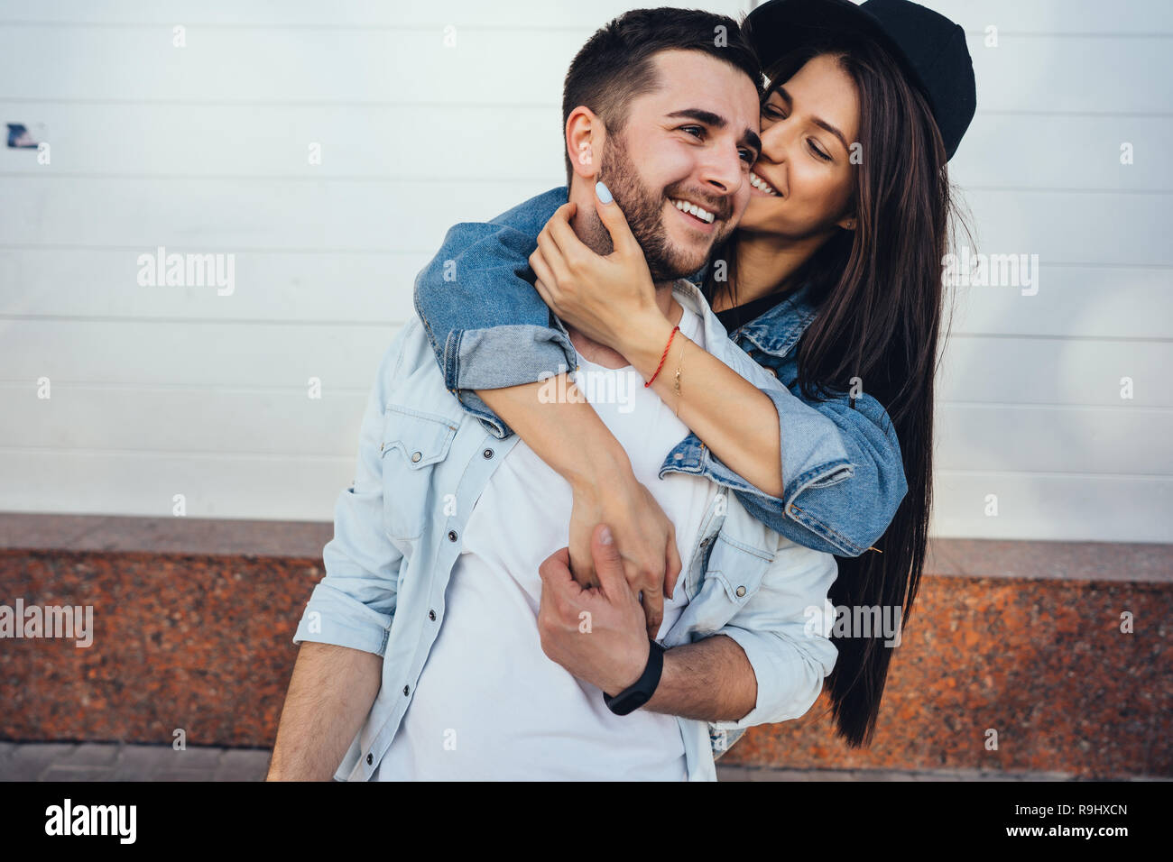 Young beautiful girl hugging her handsome boyfriend Stock Photo - Alamy