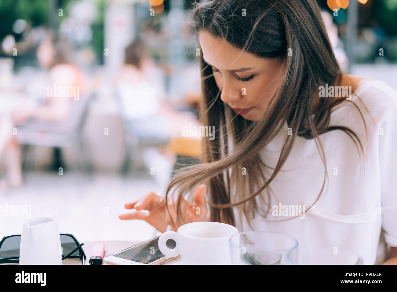 Attractive woman is sitting in a summer street cafe with a phone Stock ...