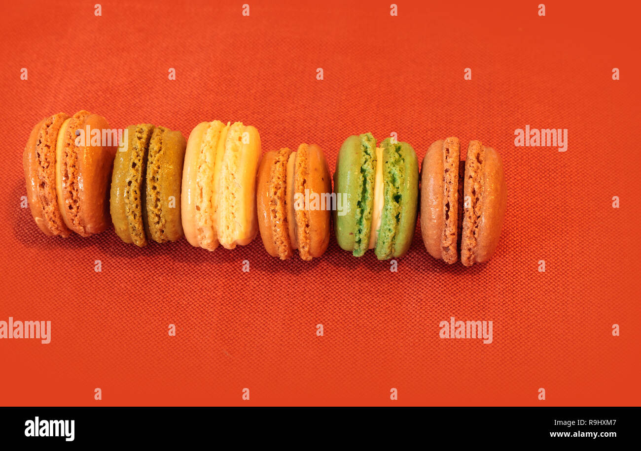French Macaroon cookies in fall colors in green, yellow and orange laid ...