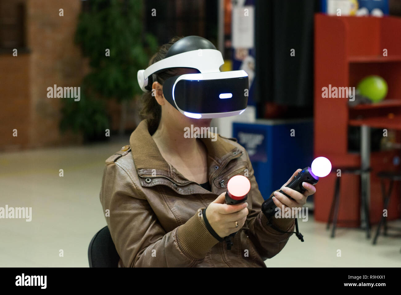 girl in VR headset who enjoying game. Virtual reality. teen in VR headset with joysticks Stock ...