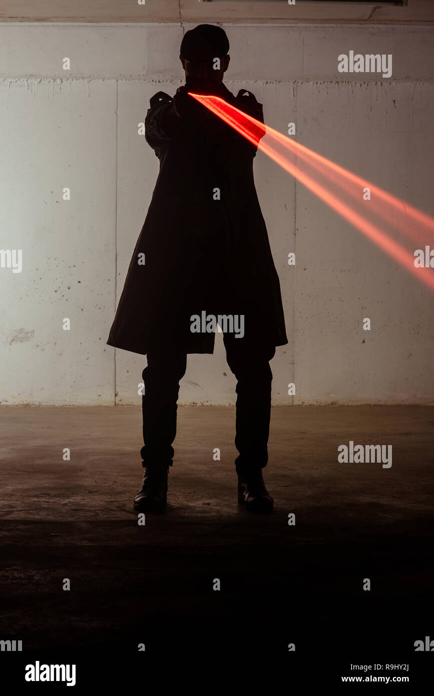 Shape of assassin man who is holding laser gun in his hands Stock Photo ...