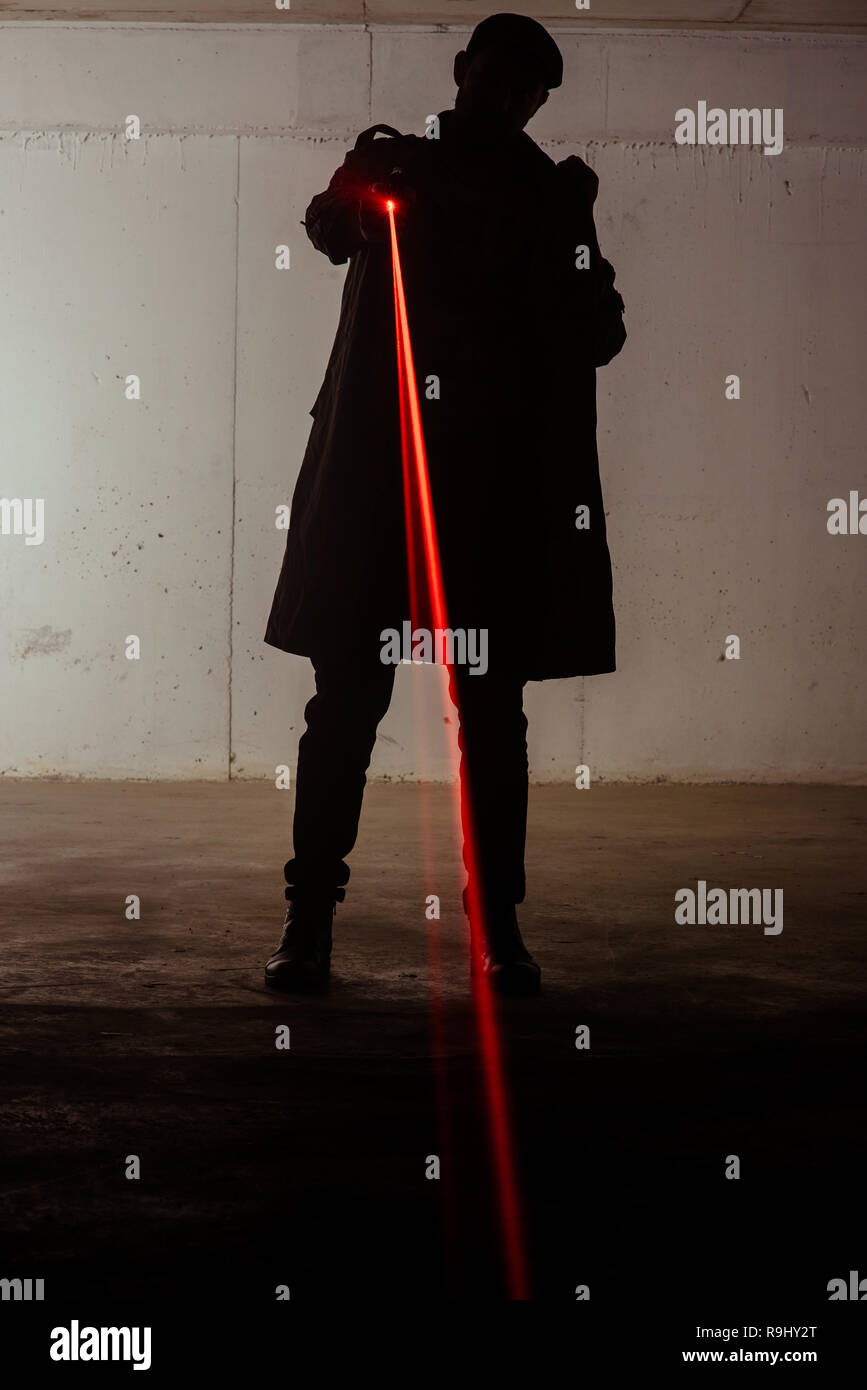 Shape of a man who is holding laser gun in his hands Stock Photo - Alamy