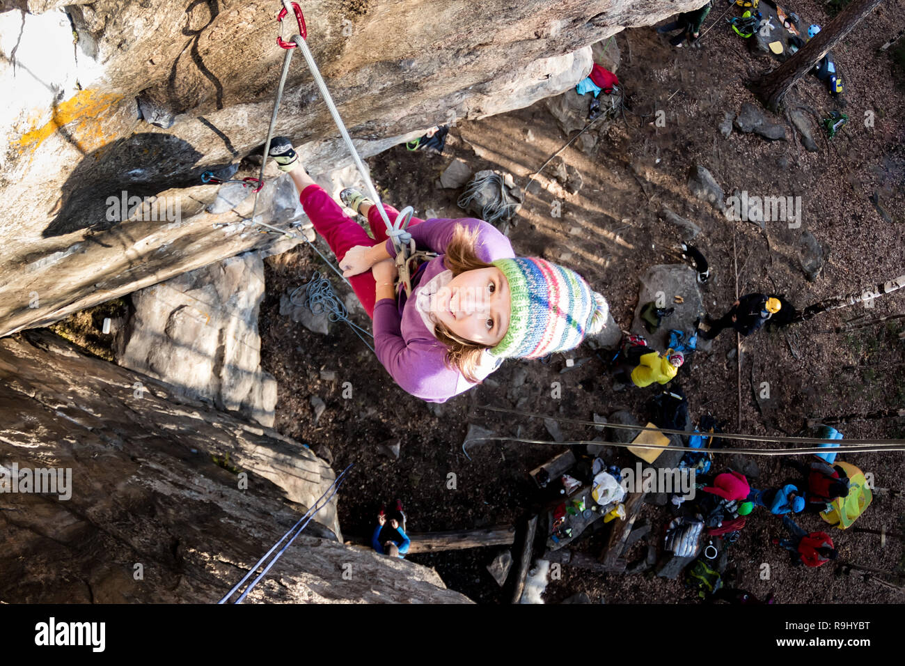 rock-climber girl crying in pain hanging on a rope with a sad face when ...