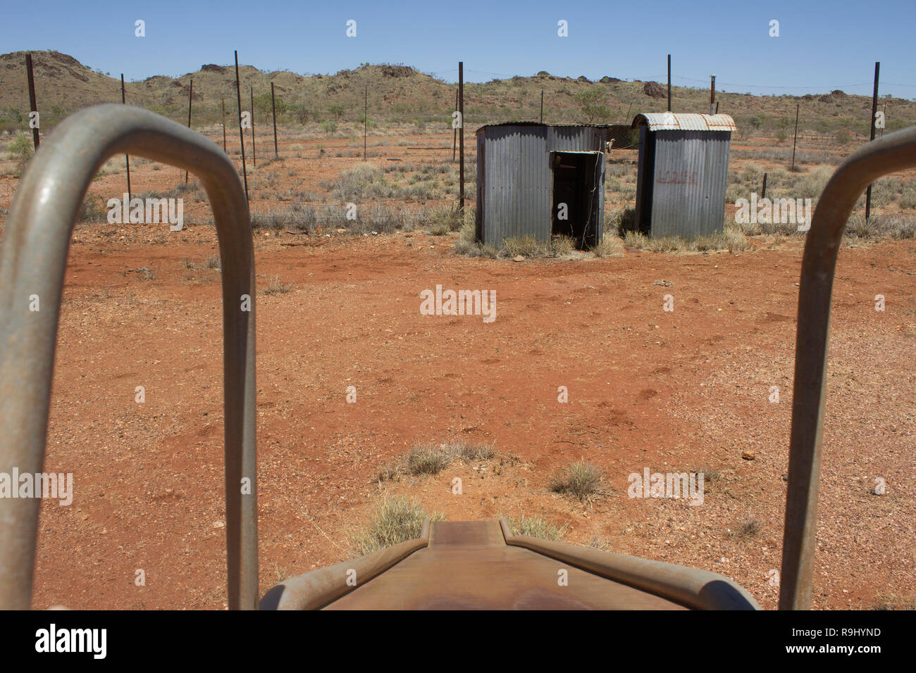 Old-fashioned metal slide in front of thunderbox toilets and abandoned ...
