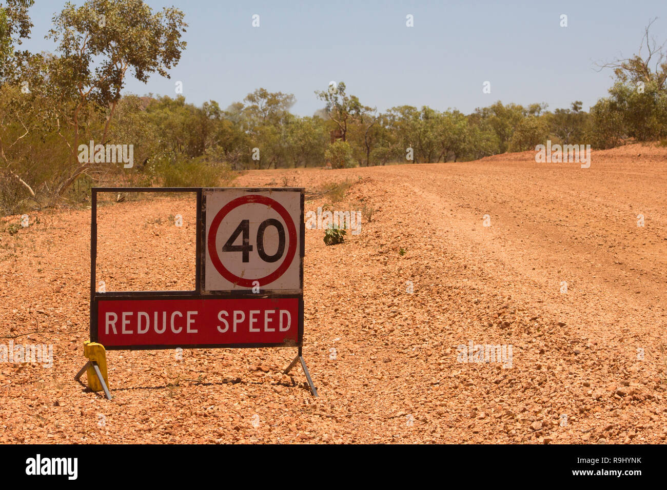 Reduce speed warning sign on a deserted stretch of road works in ...