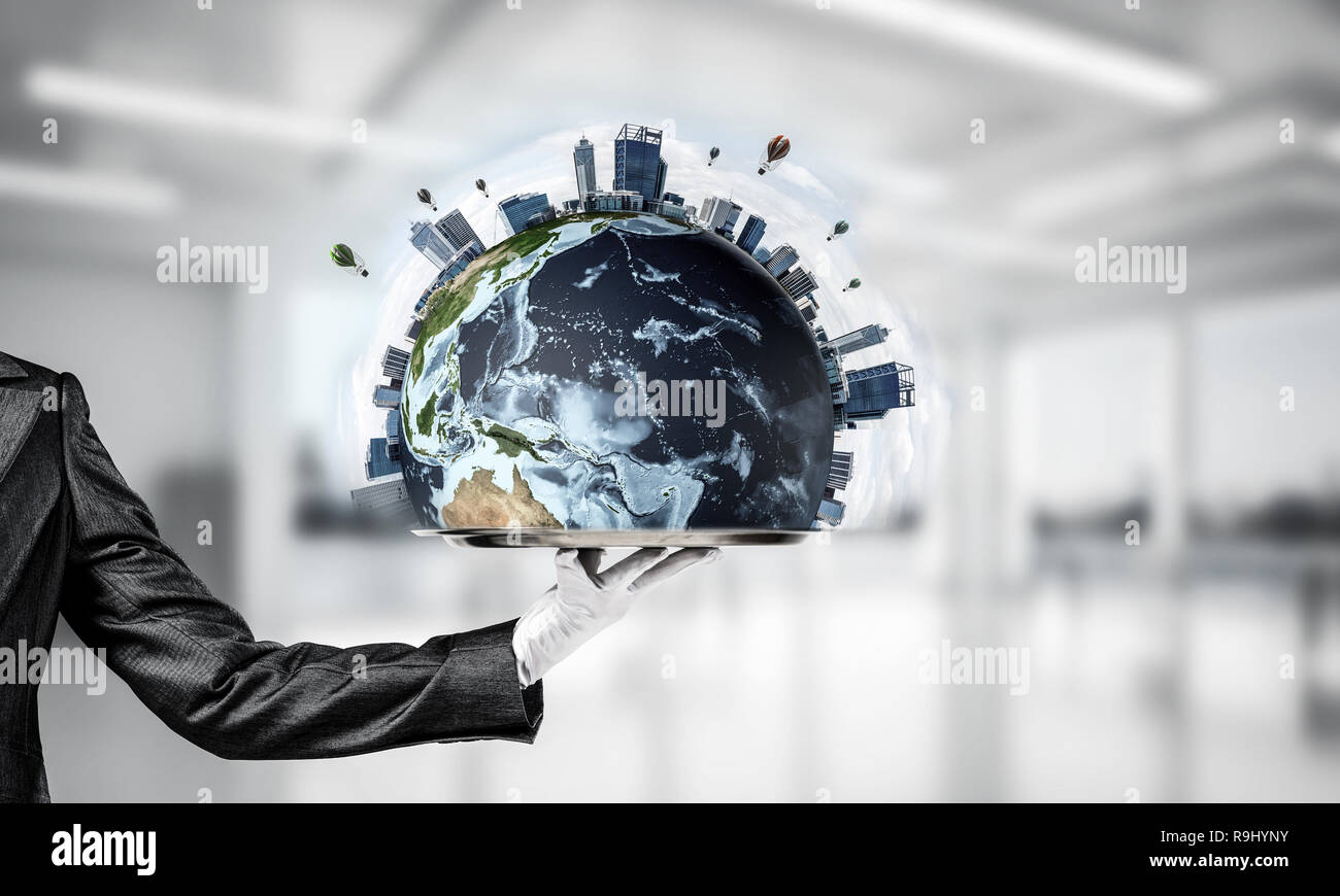 Hand of waitress presenting Earth globe on tray Stock Photo - Alamy