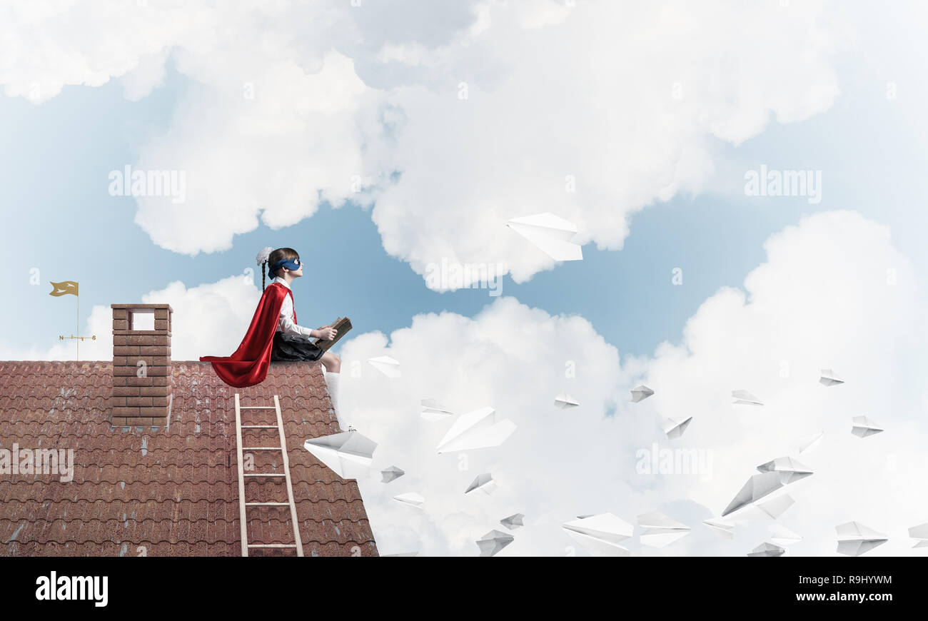 Girl power concept with cute kid guardian against cloudscape bac Stock ...