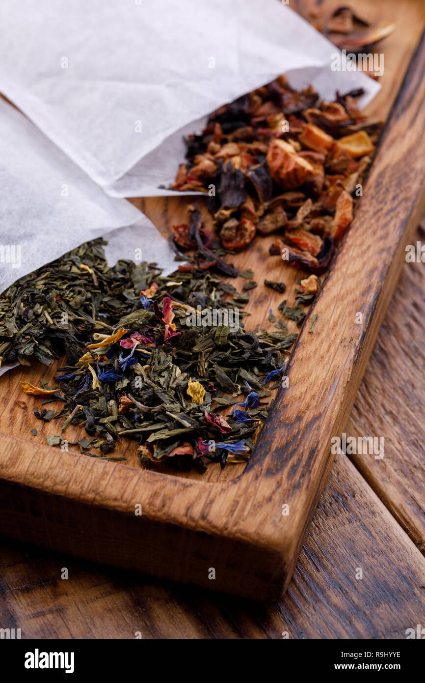 Tea specialized packages for brewing on a wooden board. Tea of ...