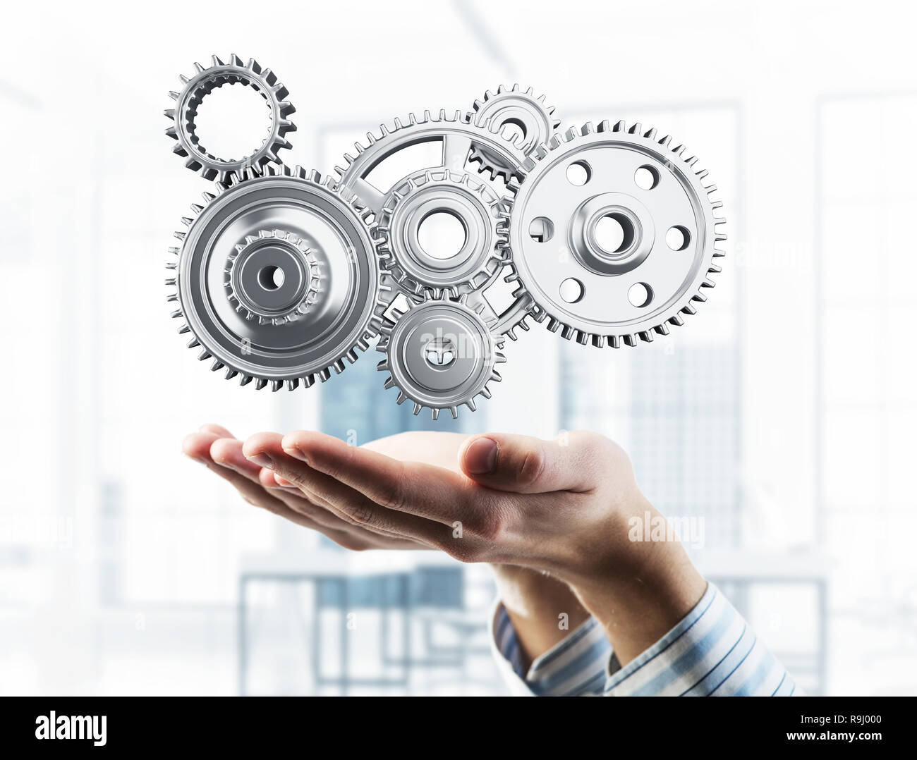 Engine mechanism in male ahnds as symbol for cooperation or team Stock ...