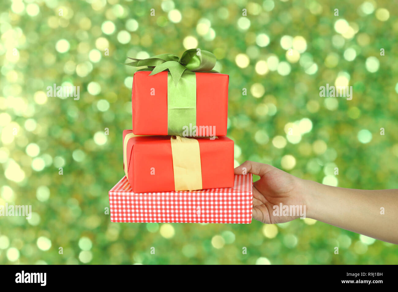 Red Gift Box on hand for Christmas concept with green blur bokeh ...