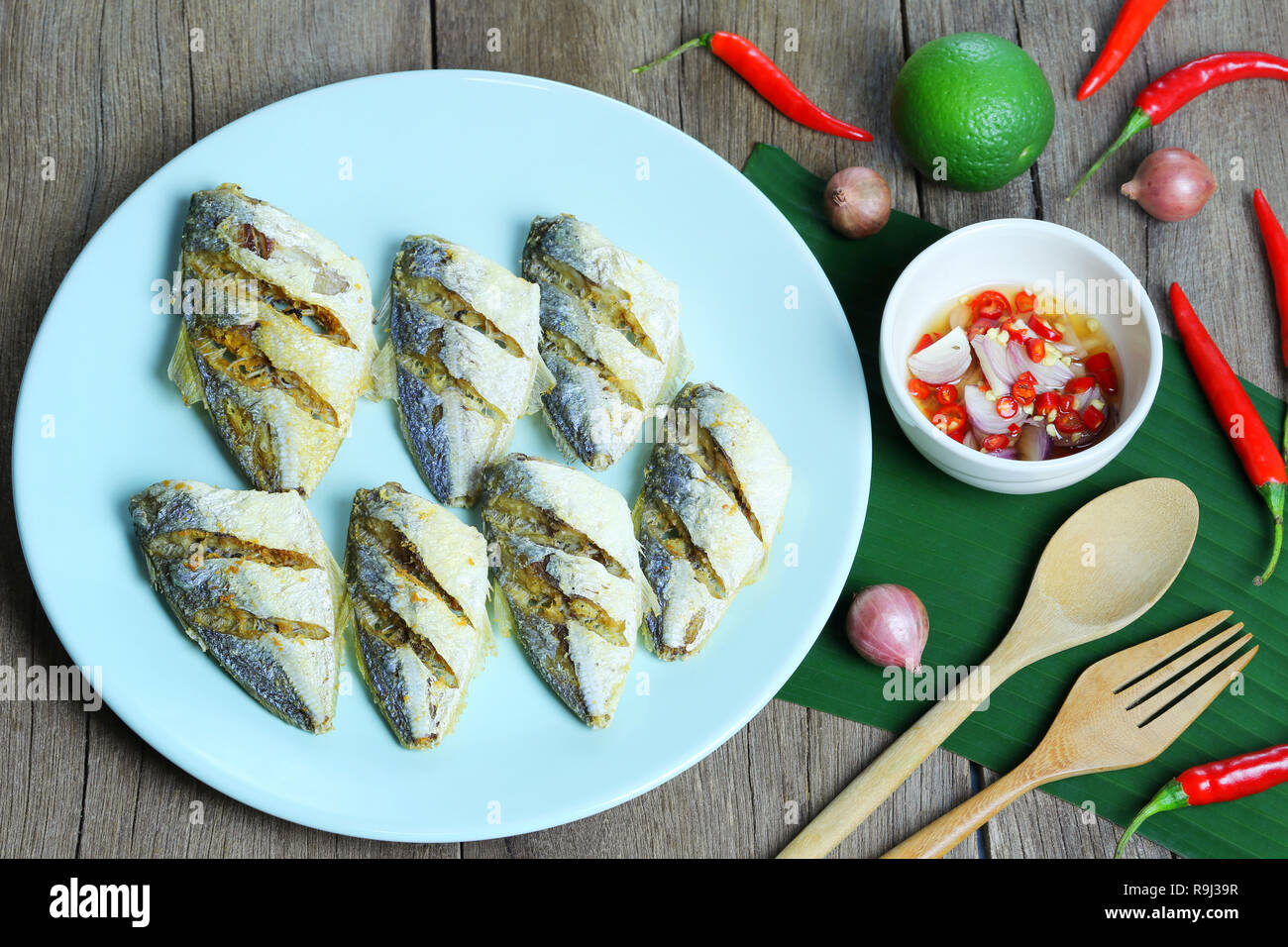 Fried Sea fish in plate and fish sauce with spicy on food table,Seafood ...