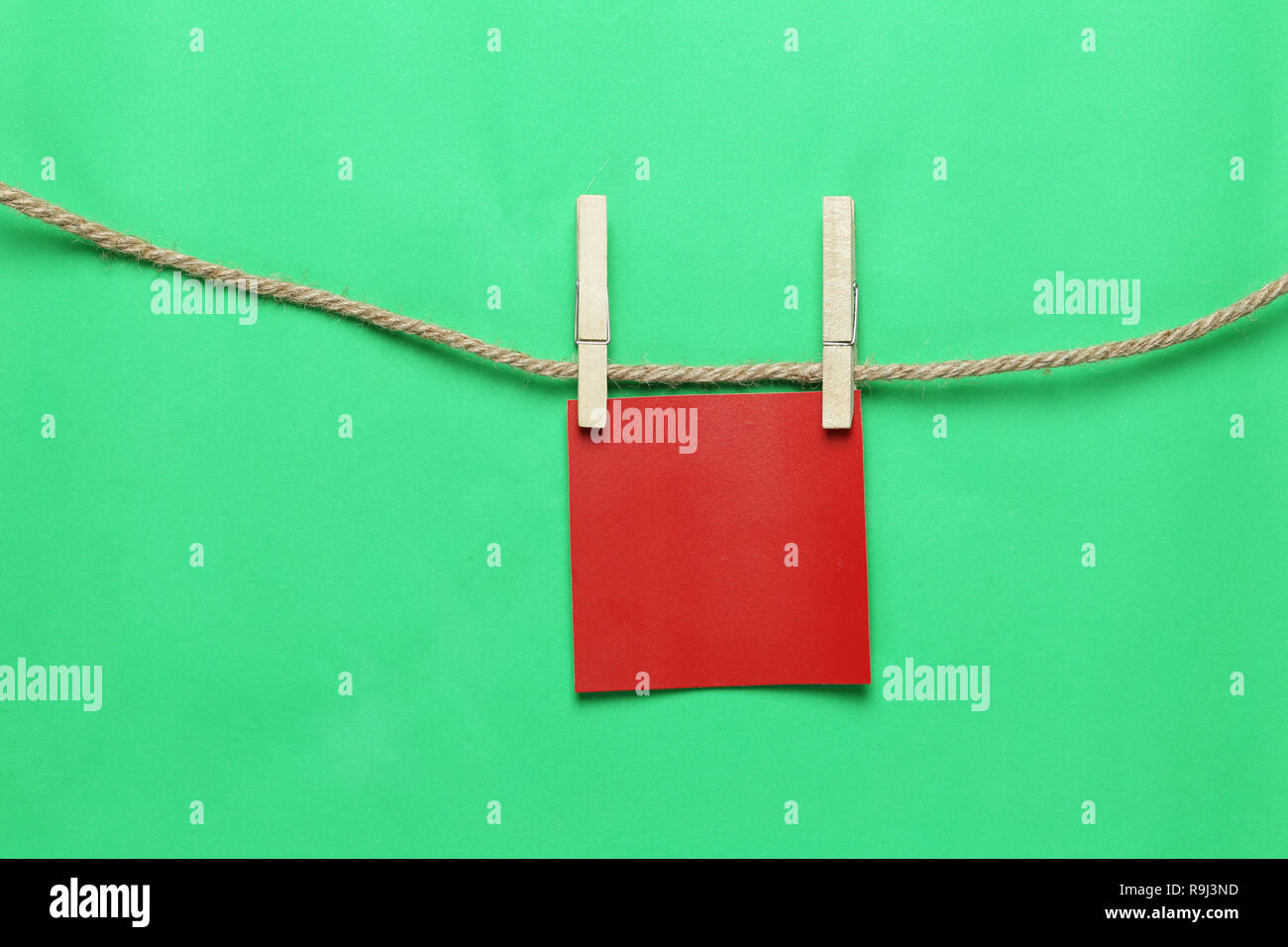 Red paper note hang on hemp rope and have copy space for design in your ...