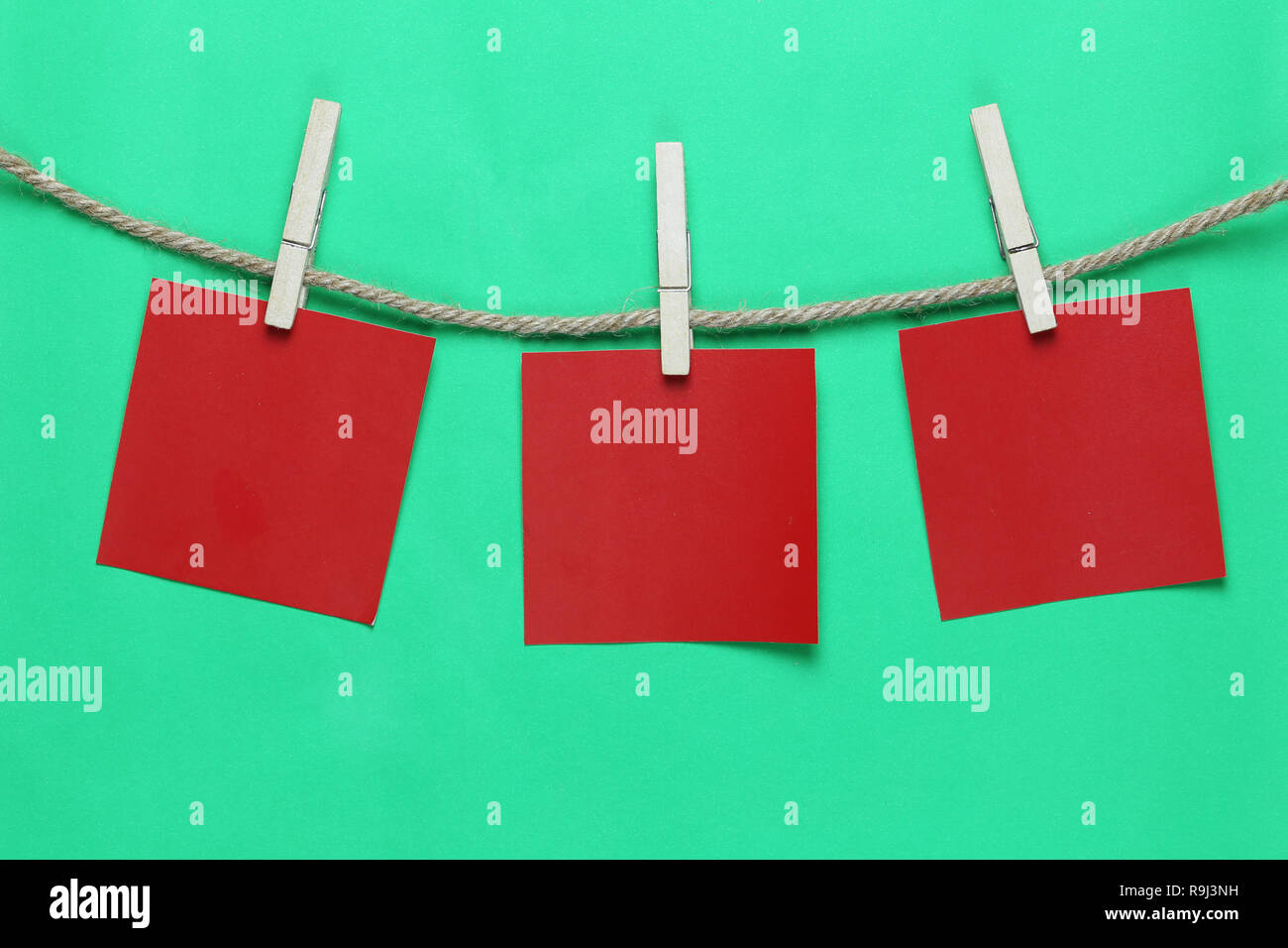 Red paper note hang on hemp rope and have copy space for design in your ...