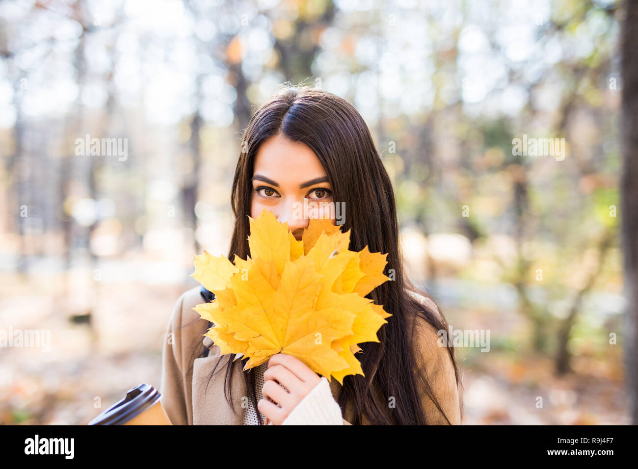 Beautiful woman with autumn leaves on fall nature background Stock ...