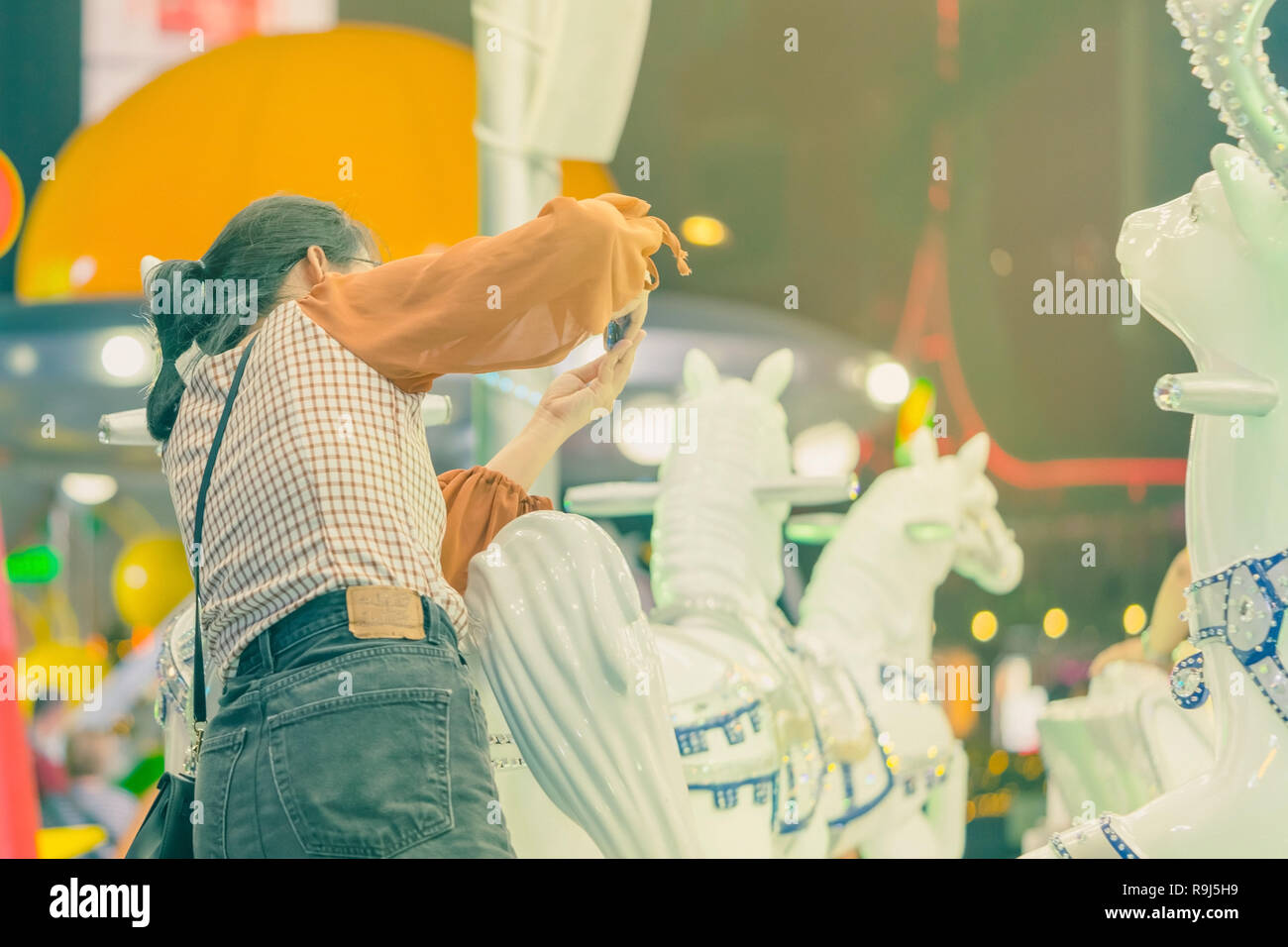 Women riding on carousel hi-res stock photography and images - Alamy