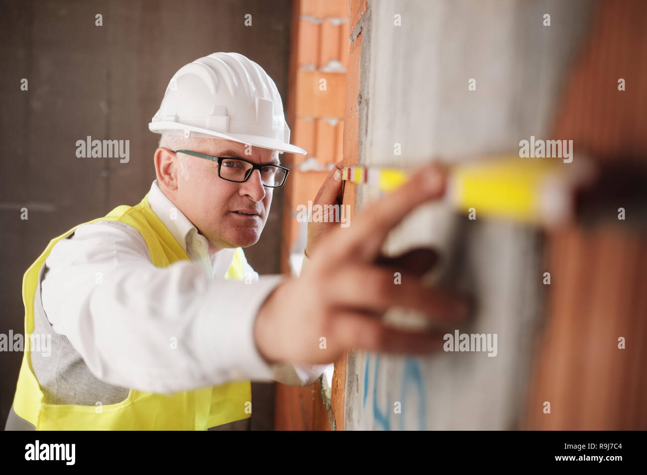 People working in construction site. Man at work in new home inside ...