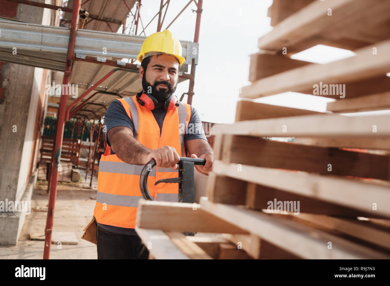 Skilled people working in construction site. Hispanic man at work in ...