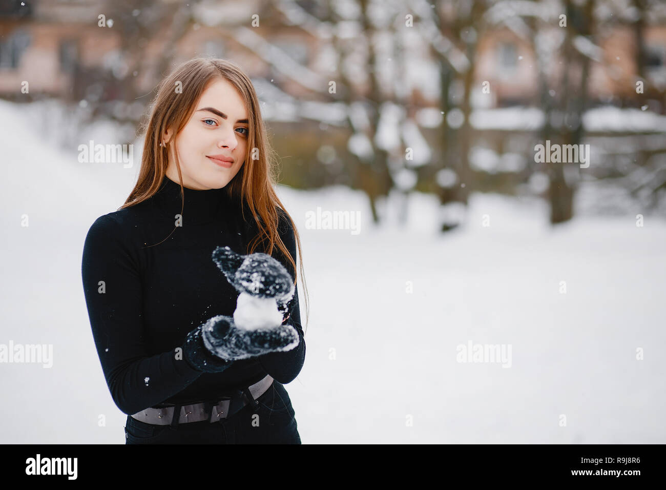 Cute girl in a winter park. Woman have fun with snow Stock Photo - Alamy