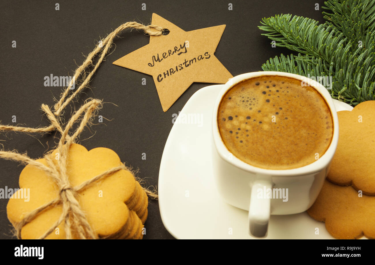 Gingerbread cookie and fresh coffee on a dark table, christmas theme ...