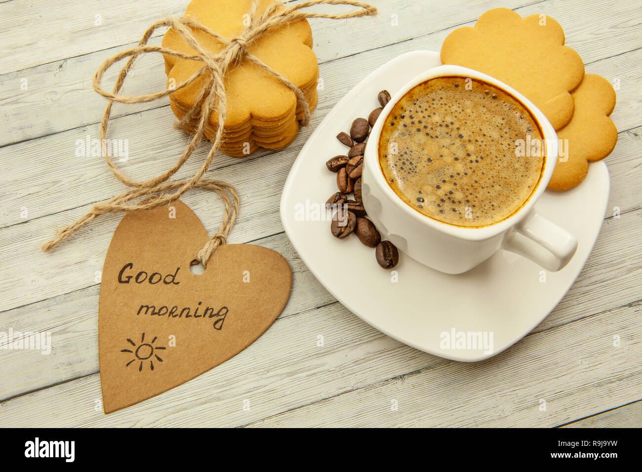 White cup with coffee, coffee beans and ginger biscuits, tasty ...