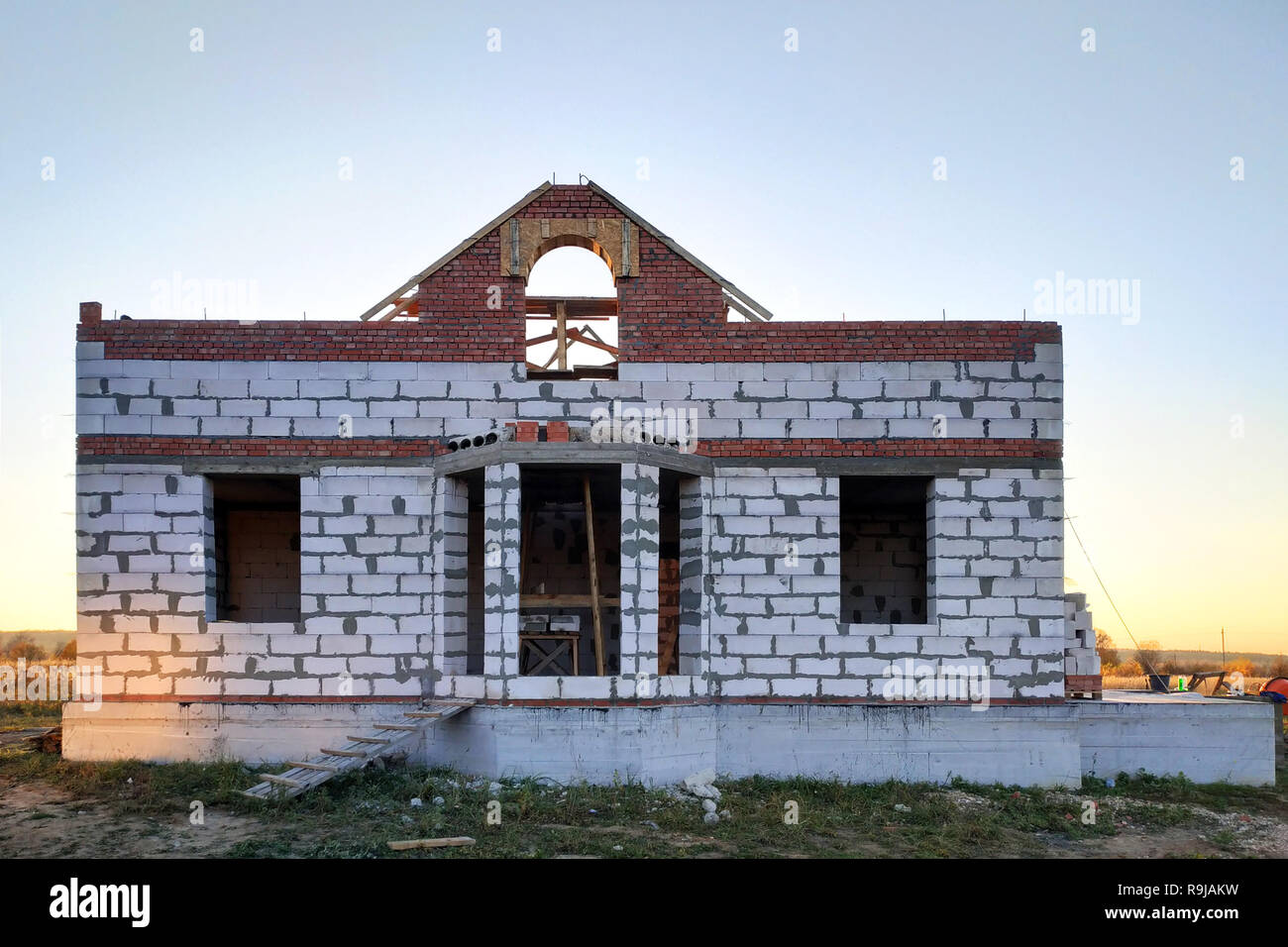 building a house in a village with blocks and bricks on the background ...