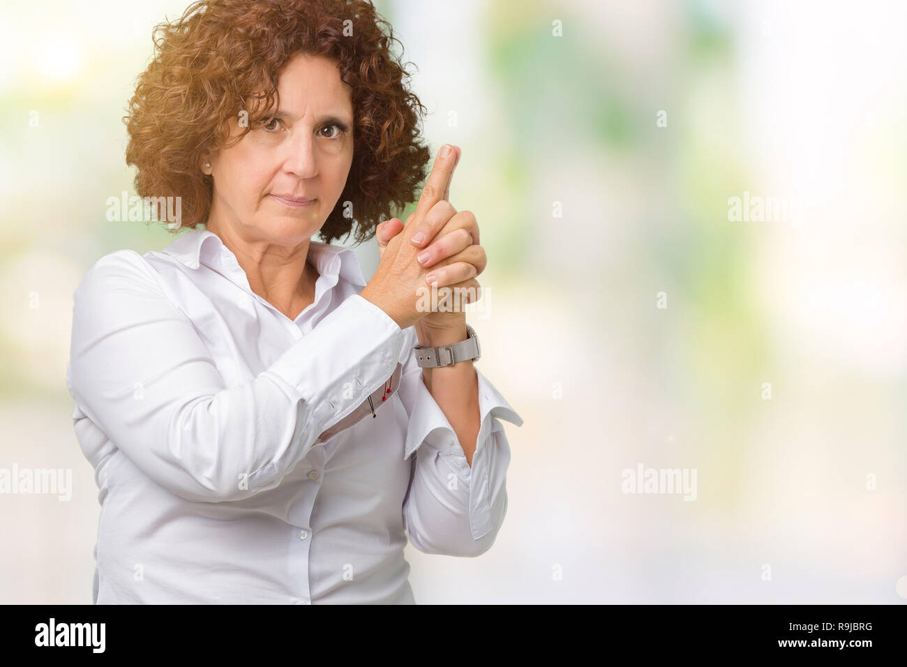 Beautiful middle ager senior businees woman over isolated background ...